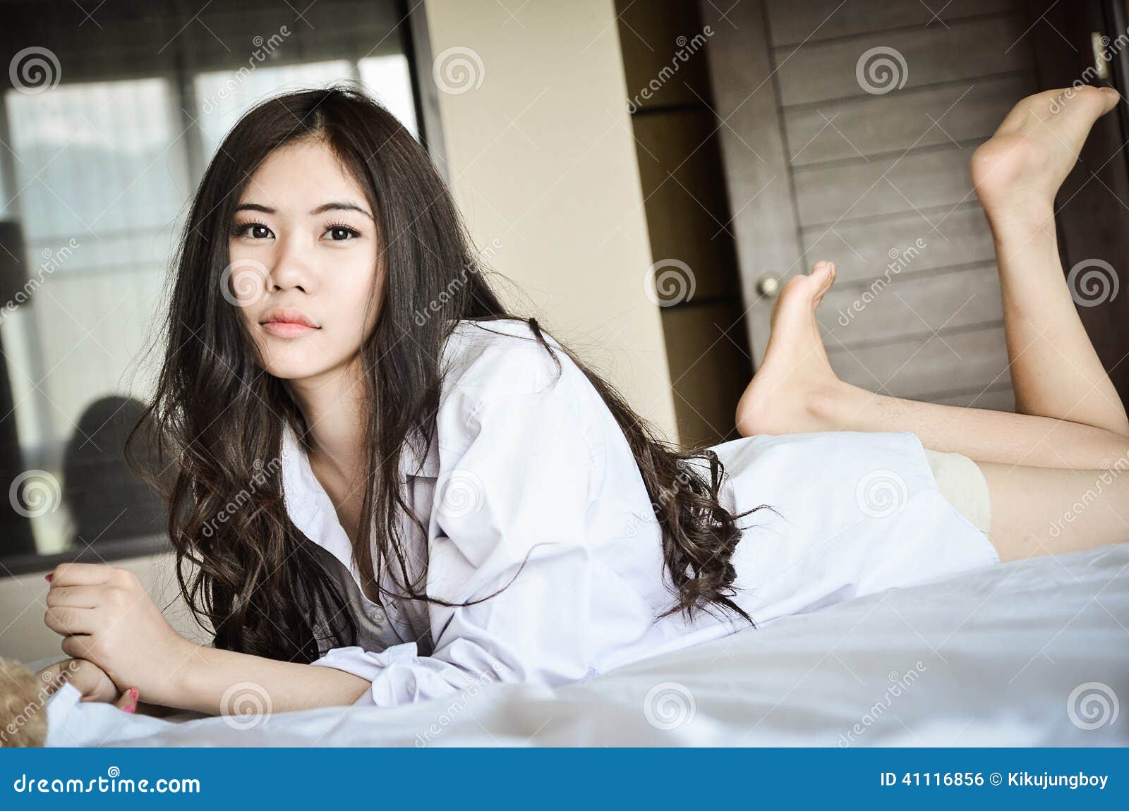 Cute girl relaxing on bed stock photo. Image of female - 41116856