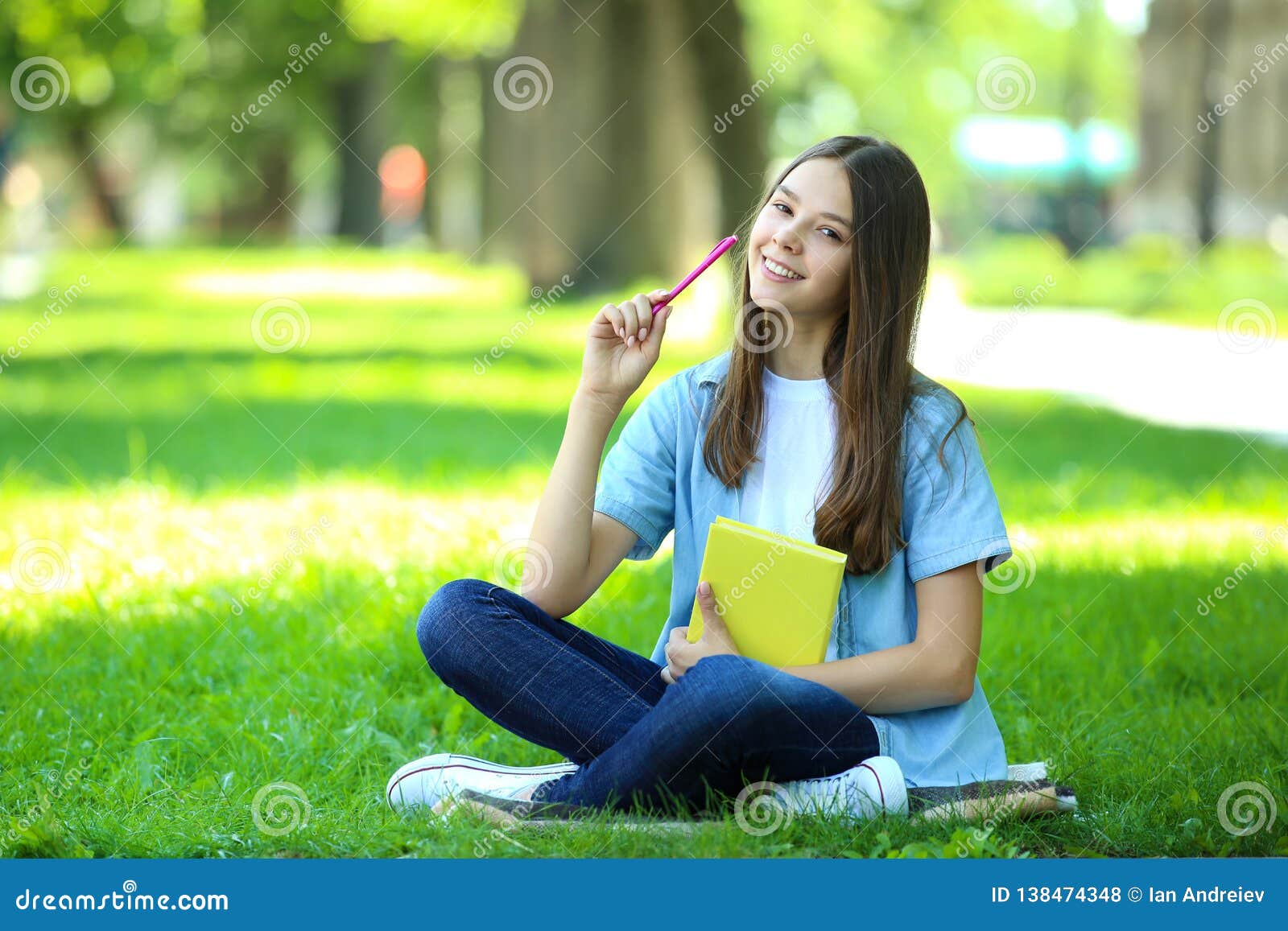Girl sitting with book stock photo. Image of jeans, people - 138474348