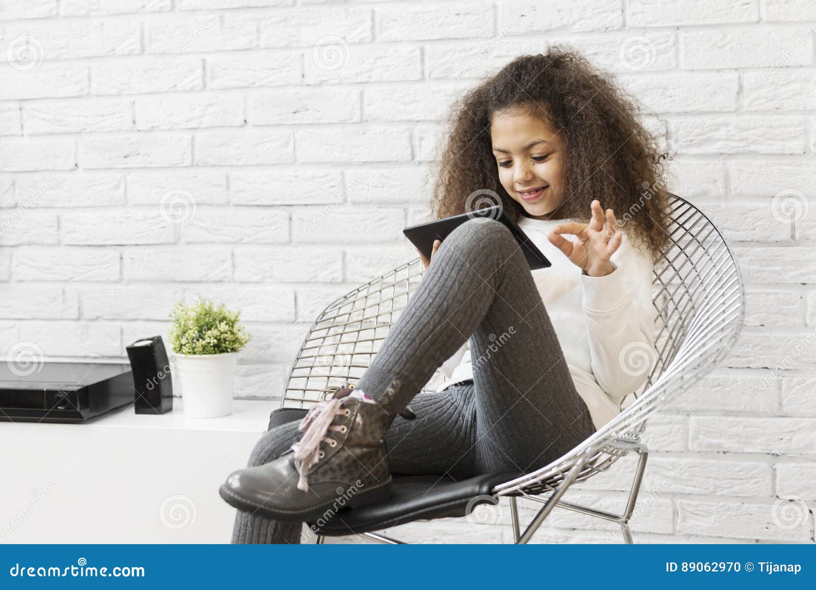 Cute girl using a tablet stock photo. Image of communication - 89062970