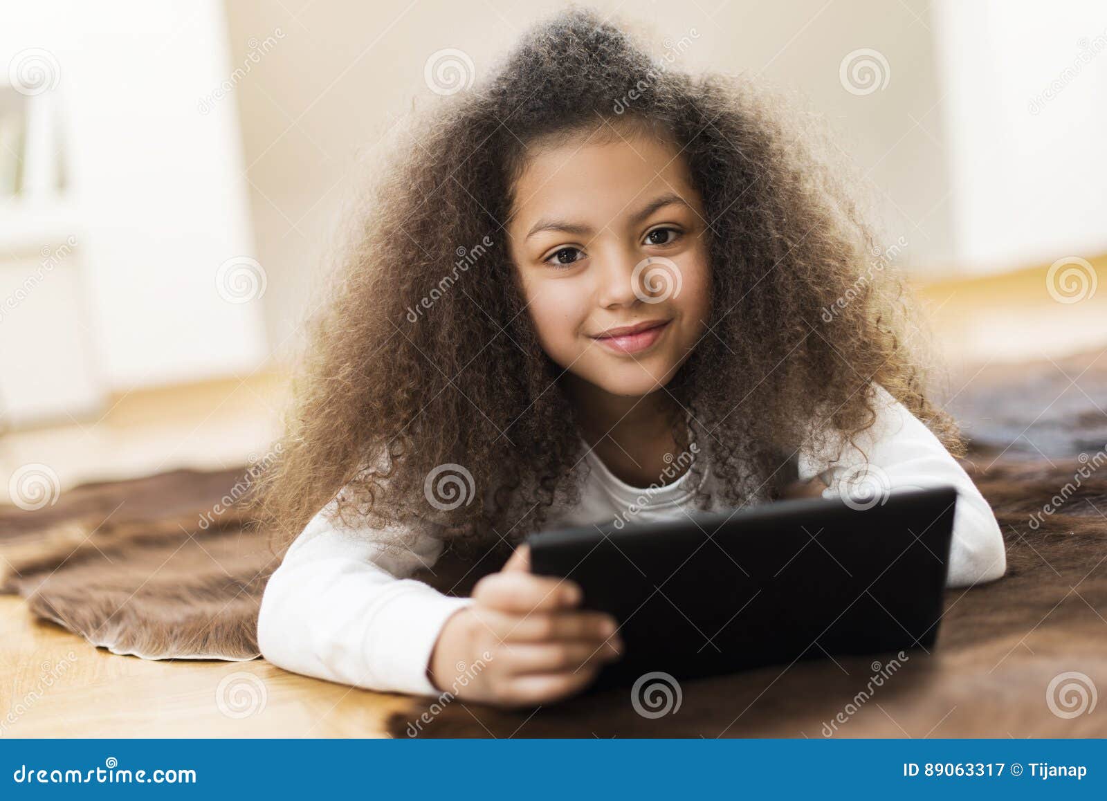 Cute girl using a tablet stock image. Image of race, video - 89063317