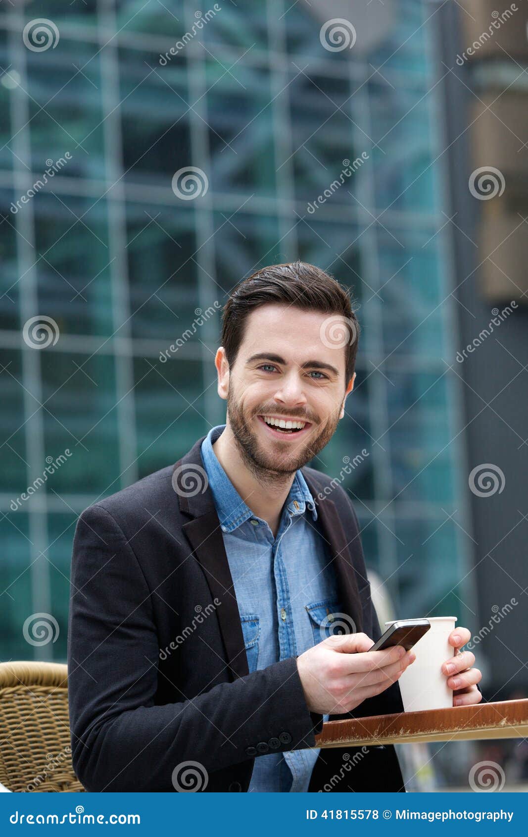 Cute Guy Smiling with Mobile Phone Stock Photo - Image of drink, male ...