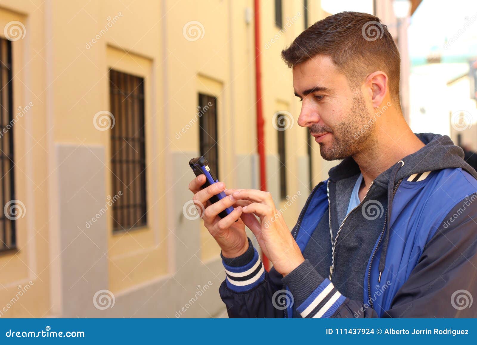Cute Guy Using His Cell Phone Outdoors Stock Photo - Image of ...