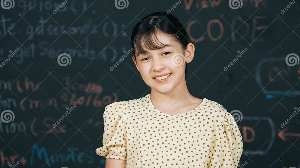 Cute Happy Girl Smiling To Camera while Standing at Blackboard ...