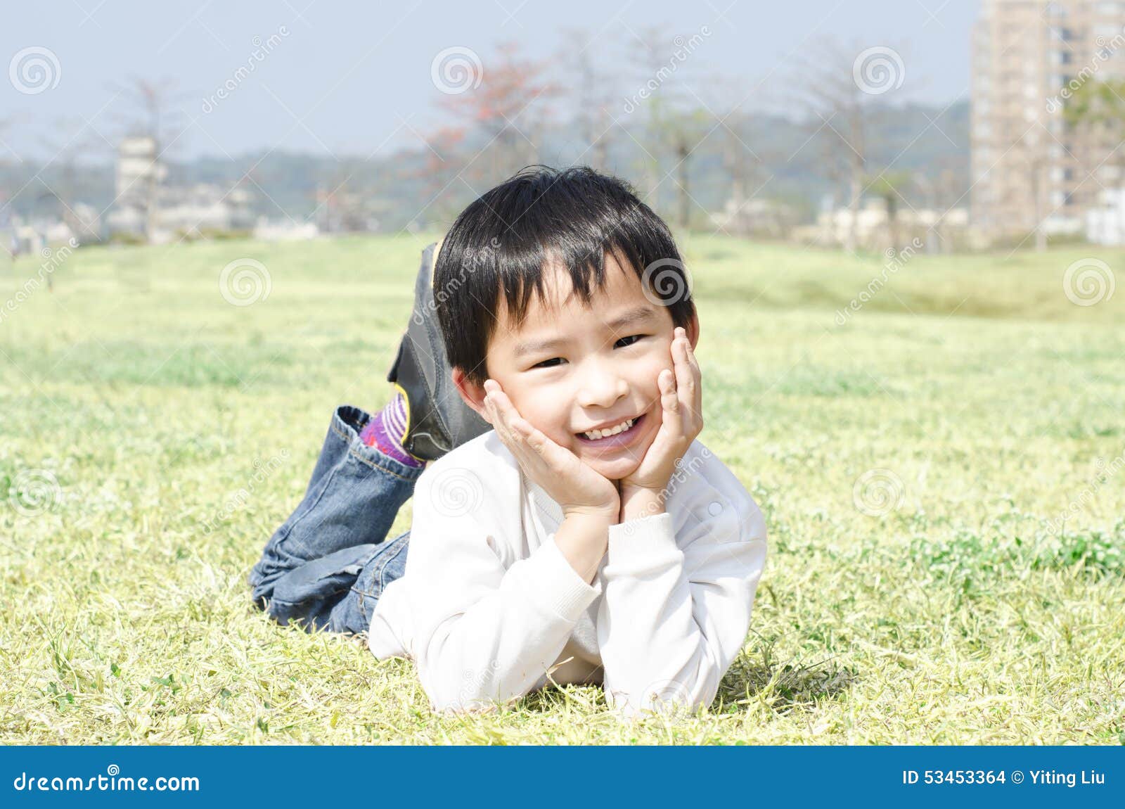 Cute Happy Kid Laying on Grass Stock Photo - Image of cheerful, green ...