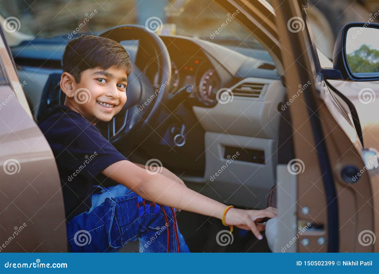 Cute Indian child in car stock image. Image of activity - 150502399