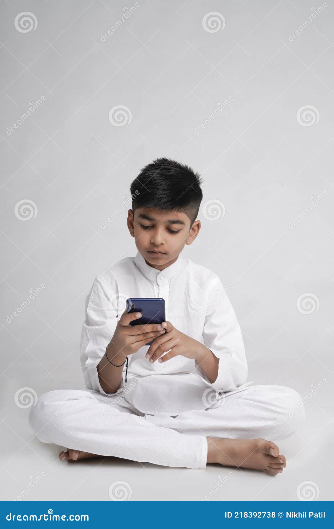 Cute Indian Little Boy Using Smart Phone Stock Photo - Image of mobile ...