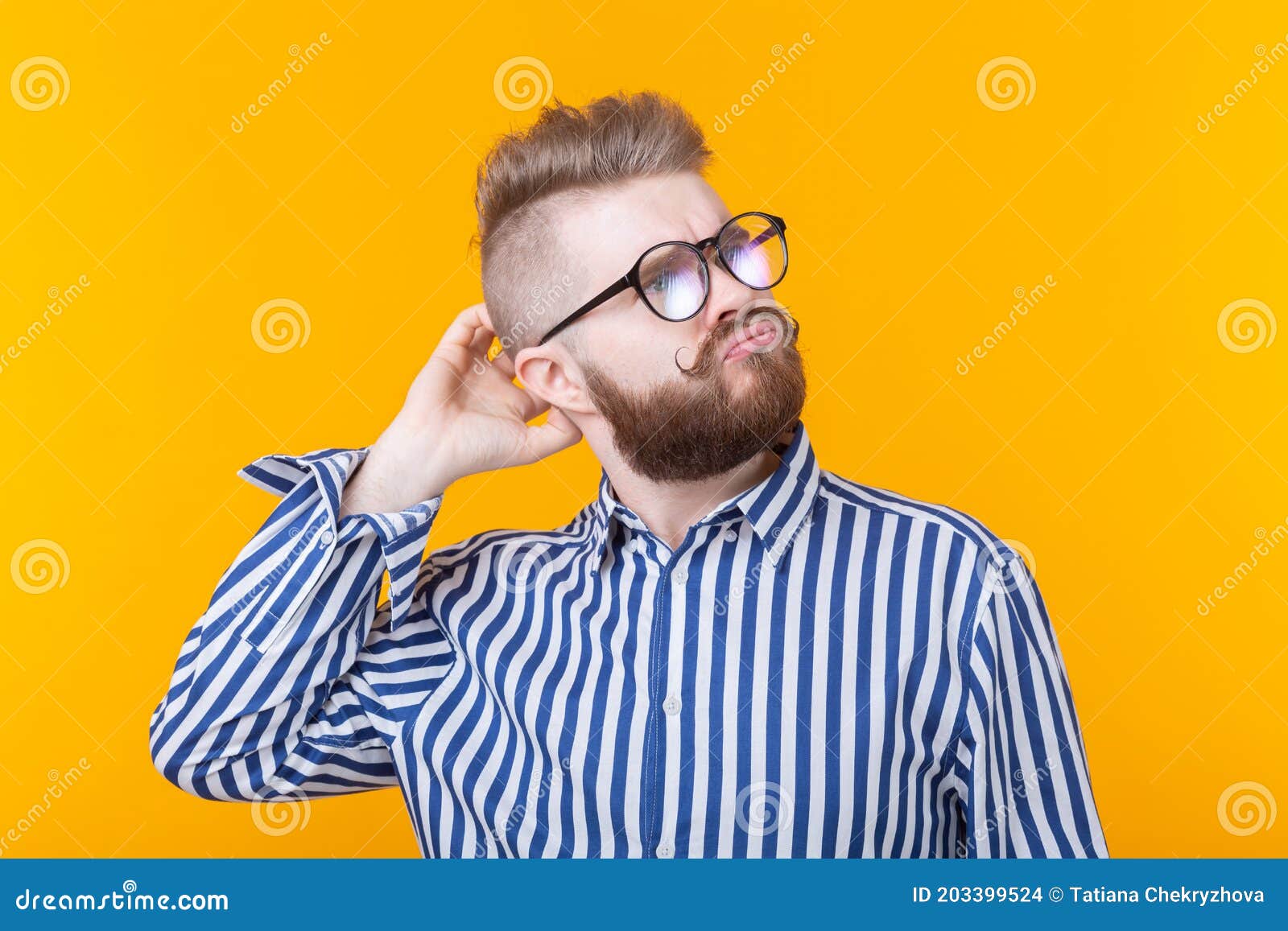 Cute Intelligent Young Man with a Beard and with Glasses Poses on a ...