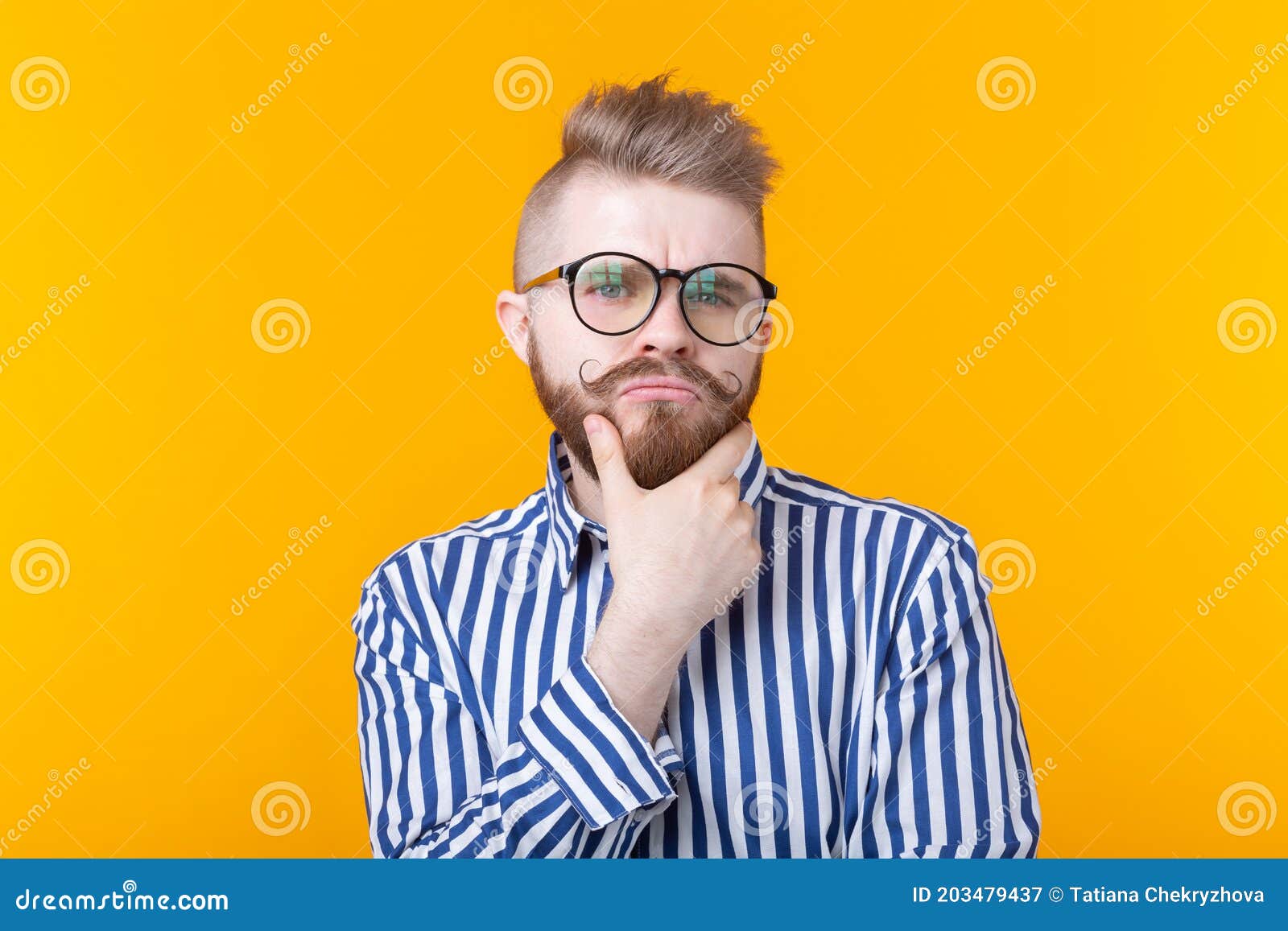 Cute Intelligent Young Man with a Beard and with Glasses Poses on a ...