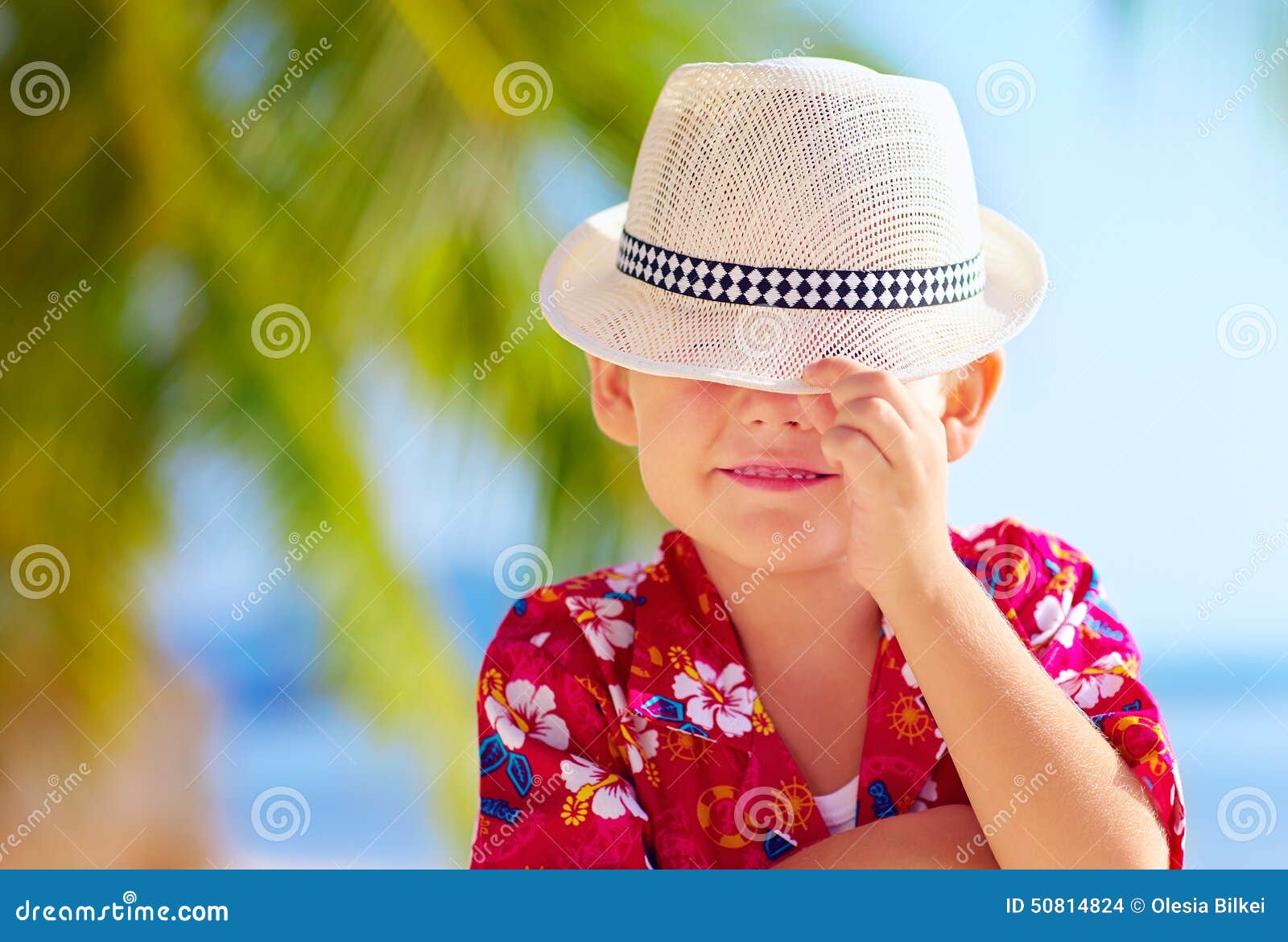 Cute Kid Boy Hiding His Face Behind Hat Stock Photo - Image of hawaii ...