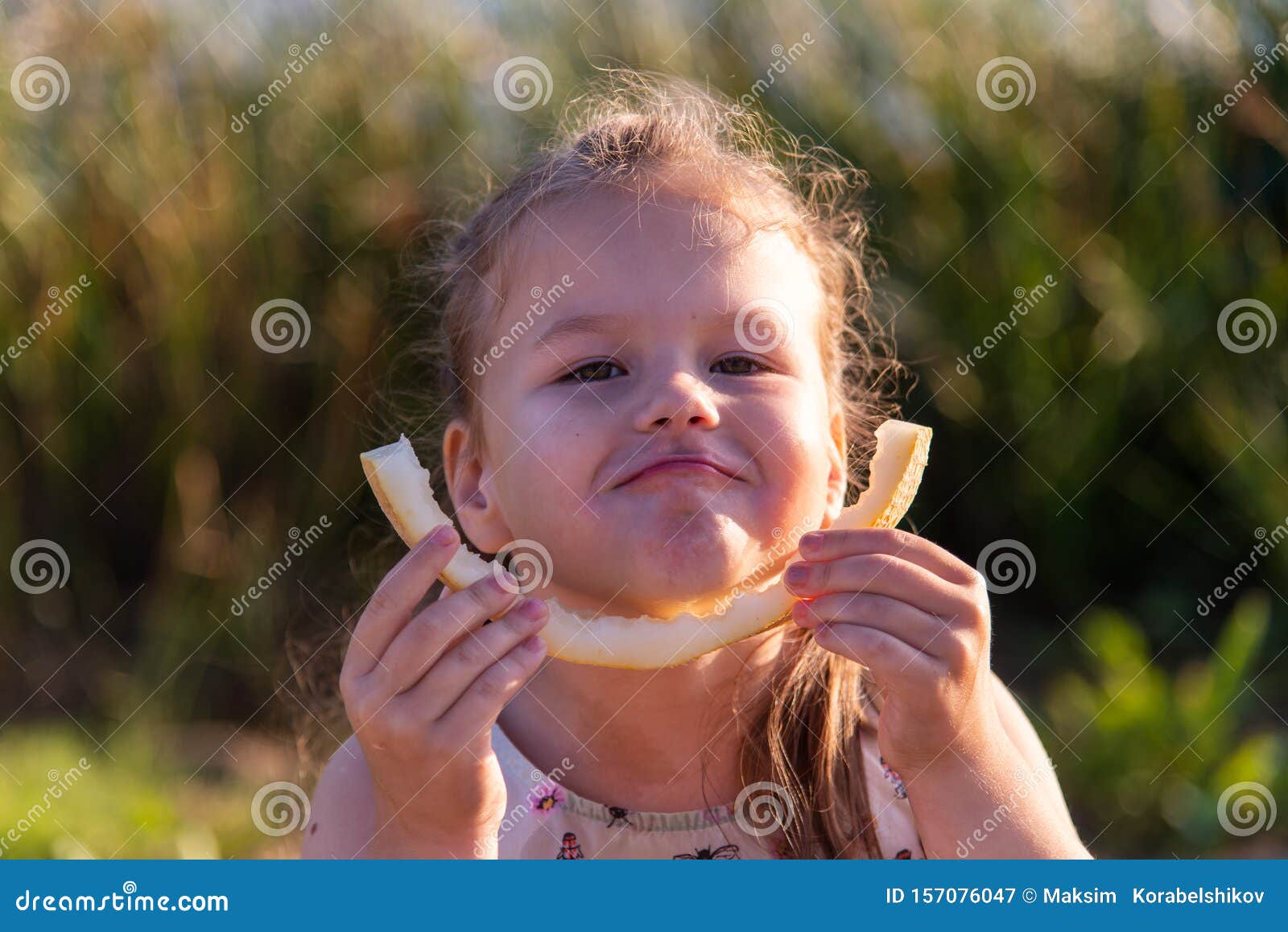 Cute Kid Eating Melon.have Fun and Grimaces Stock Image - Image of ...