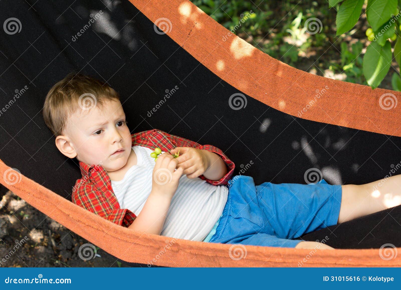 A Cute Kid Lying on the Swing Stock Photo - Image of elated, laughter ...