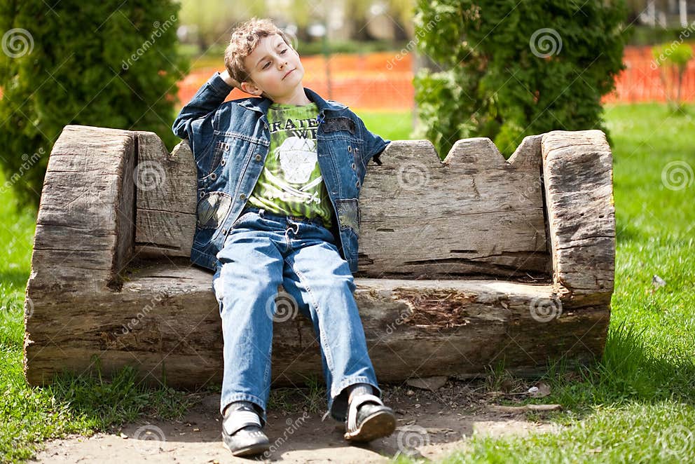 Cute kid sitting on bench stock image. Image of smile - 13755689