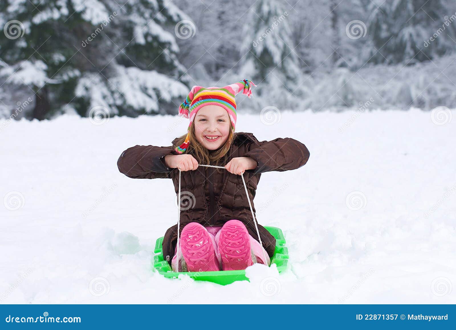 Cute kid on a snow sled stock image. Image of winter - 22871357