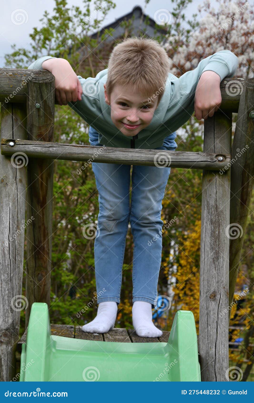 Cute boy plays on a slide stock photo. Image of female - 275448232