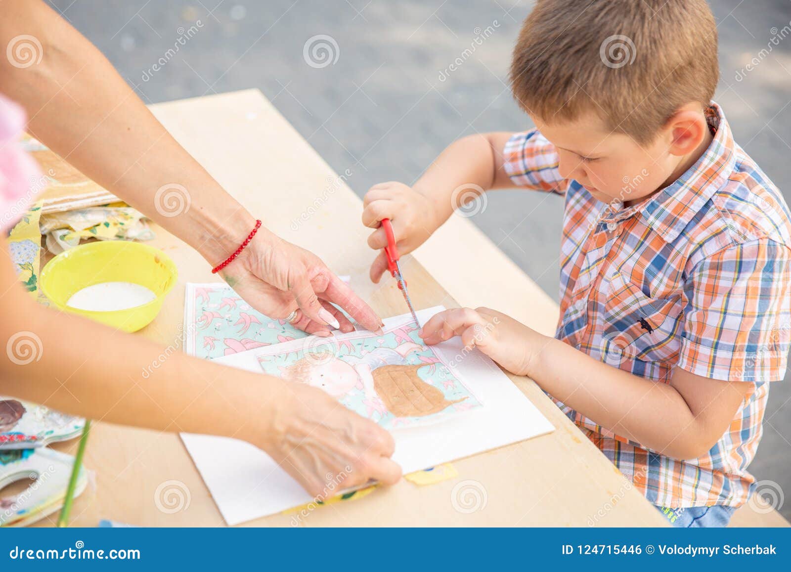 Cute Little Boy Cutting Shapes Out of Colored Paper. Being Creative ...