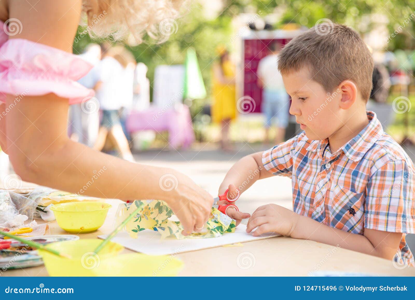 Cute Little Boy Cutting Shapes Out of Colored Paper. Being Creative ...