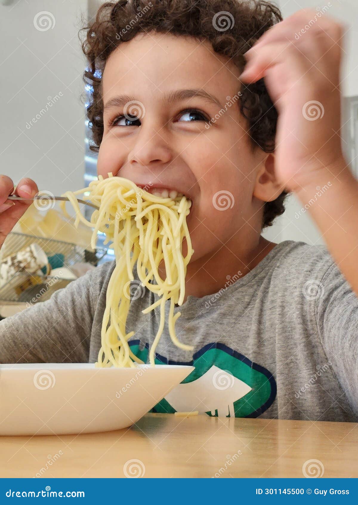 Cute Little Boy Eating Spaghetti in the Kitchen. Healthy Eating Concept ...
