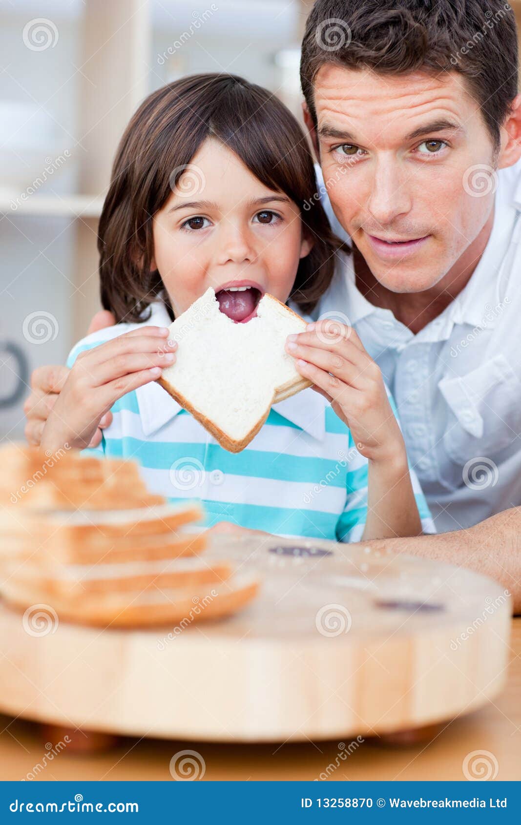 Cute Little Boy and His Father Eating Bread Stock Photo - Image of ...