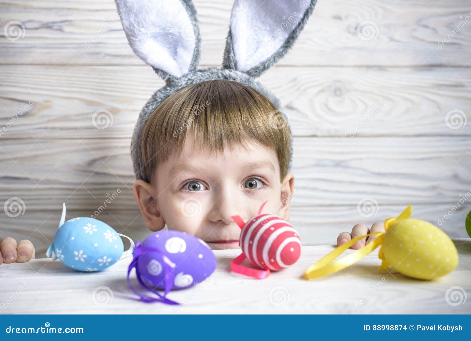 Cute Little Boy Holding a Nest with Colored Easter Eggs at Home on ...