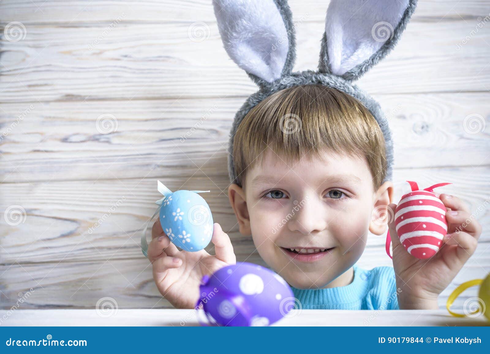 Cute Little Boy Holding a Nest with Colored Easter Eggs at Home on ...