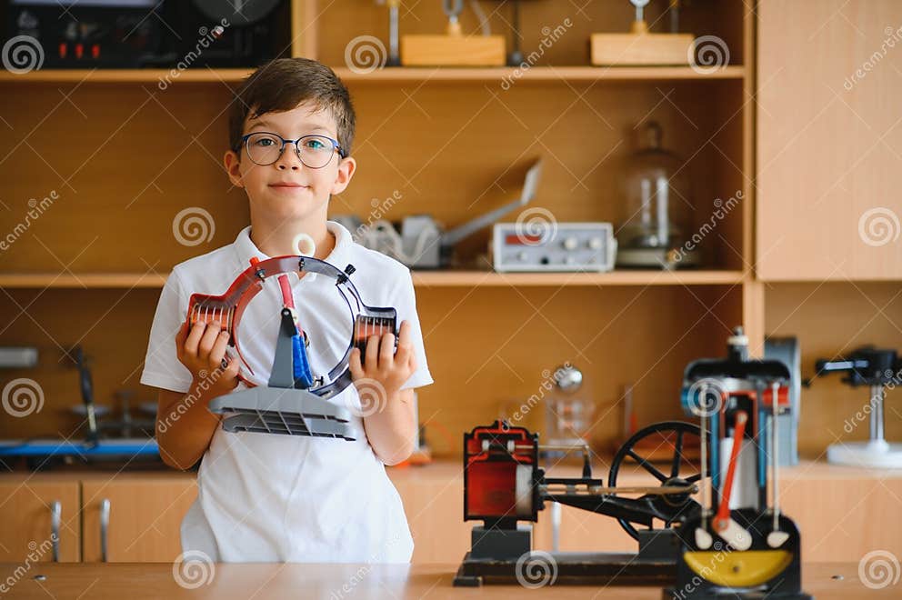 Cute Little Boy at Physics Lesson in Classroom Stock Photo - Image of ...
