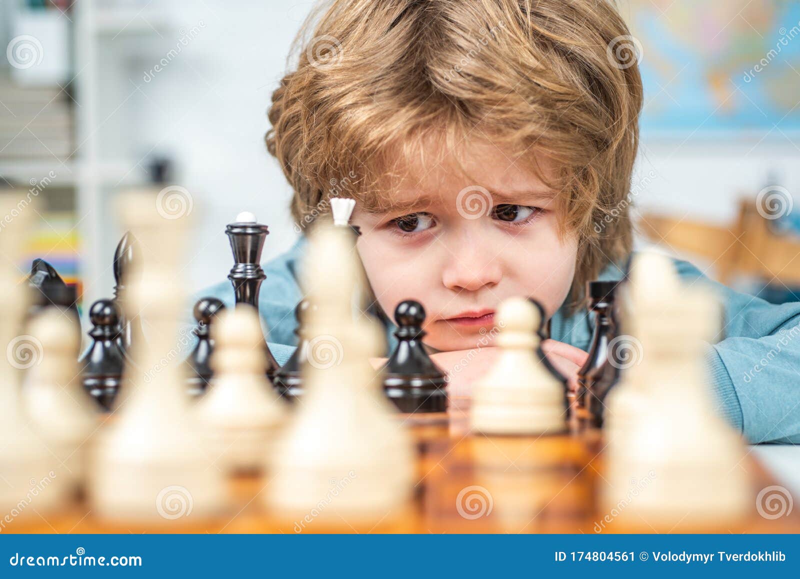 Cute Little Boy Playing Chess. Thinking Kid. Concentrated Boy ...