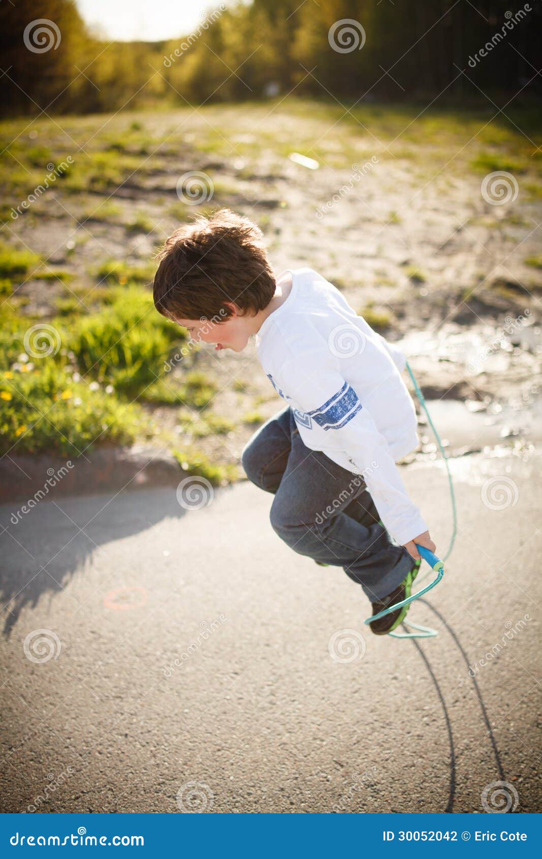 Boy playing jump rope stock photo. Image of young, light - 30052042