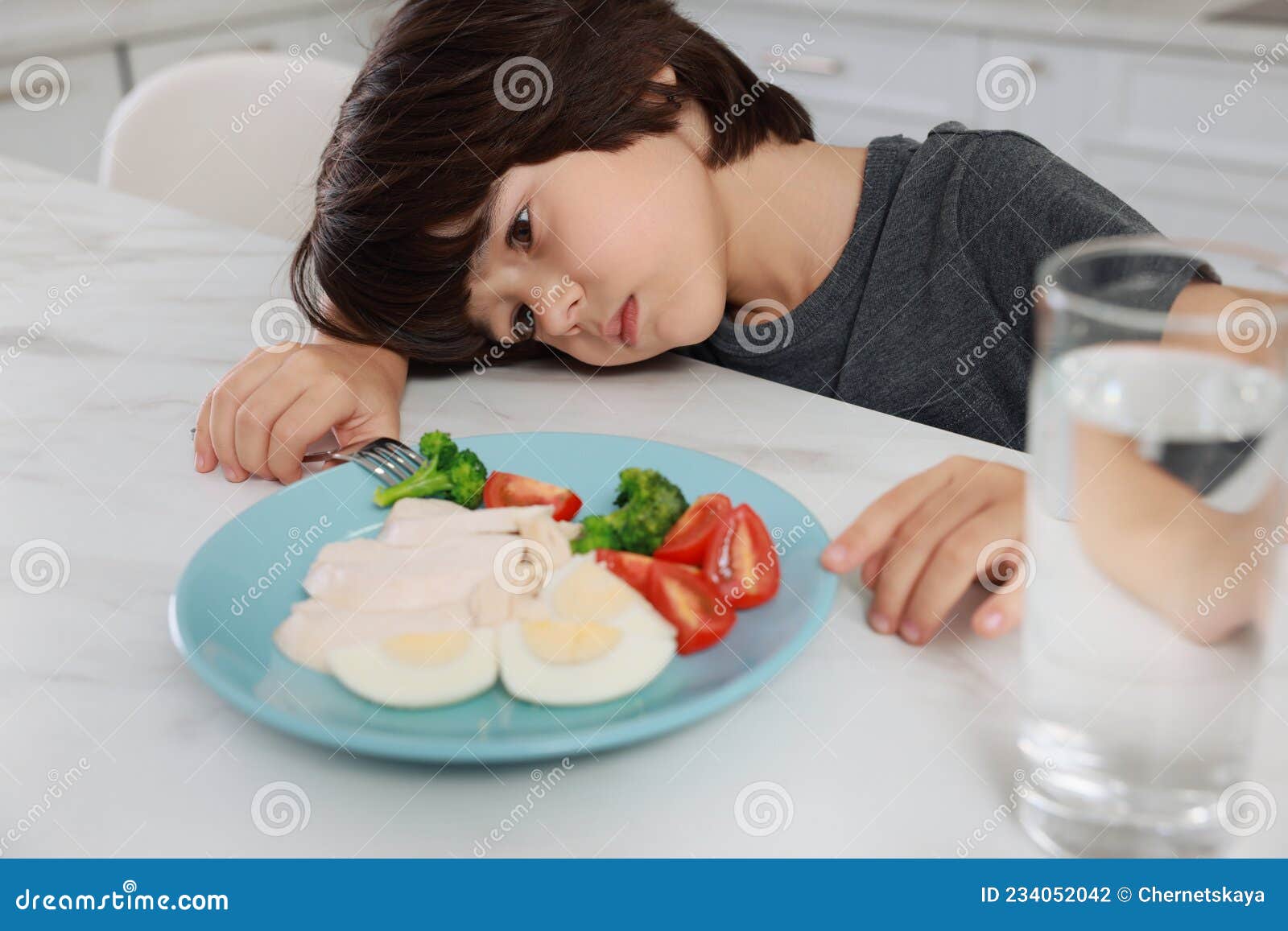 Cute Little Boy Refusing To Eat Dinner in Kitchen Stock Photo - Image ...