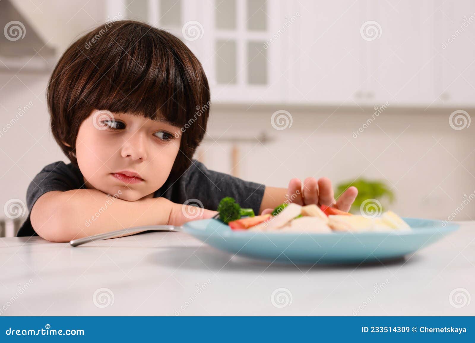Cute Little Boy Refusing To Eat Dinner in Kitchen Stock Image - Image ...