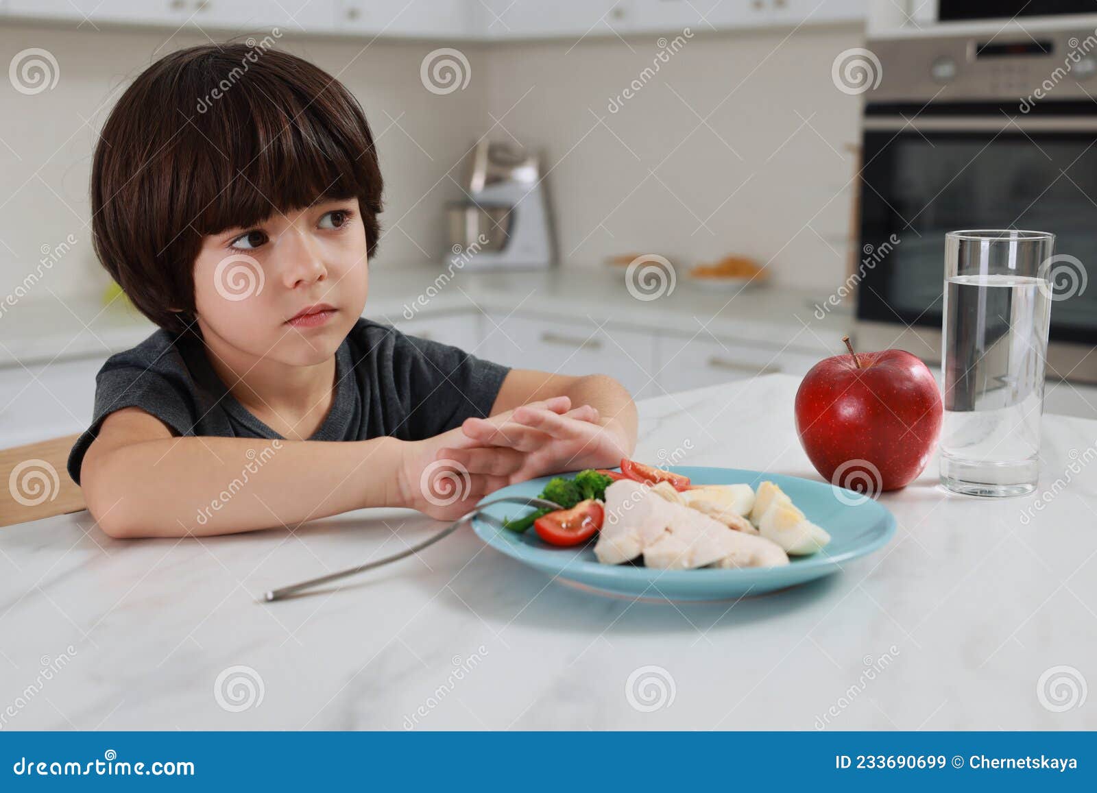 Cute Little Boy Refusing To Eat Dinner in Kitchen Stock Image - Image ...