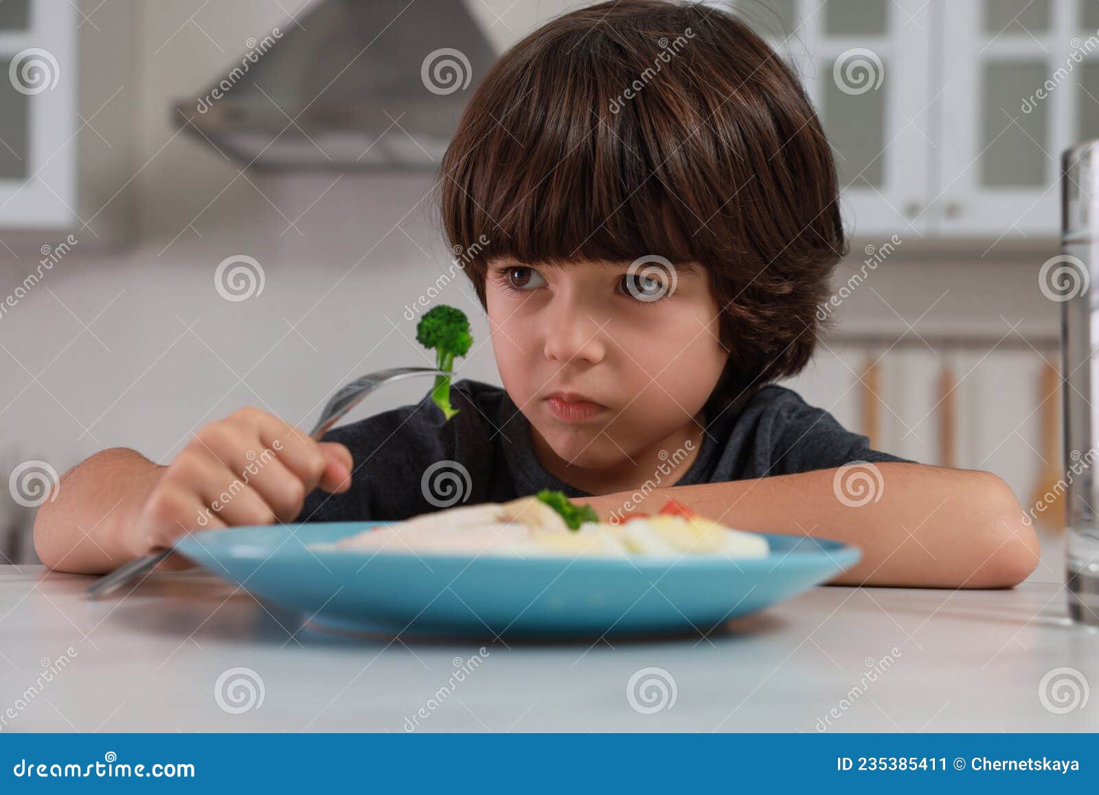 Cute Little Boy Refusing To Eat Dinner in Kitchen Stock Image - Image ...