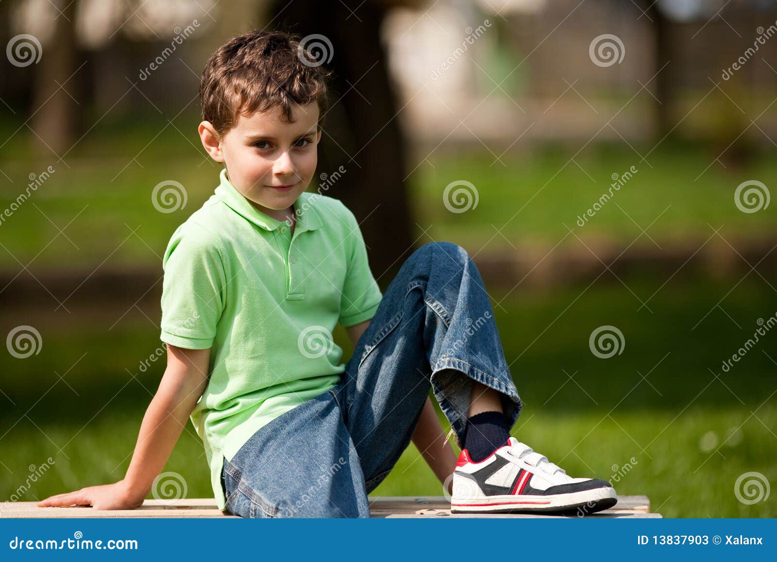 Cute Little Boy Sitting on a Bench Stock Image - Image of green ...