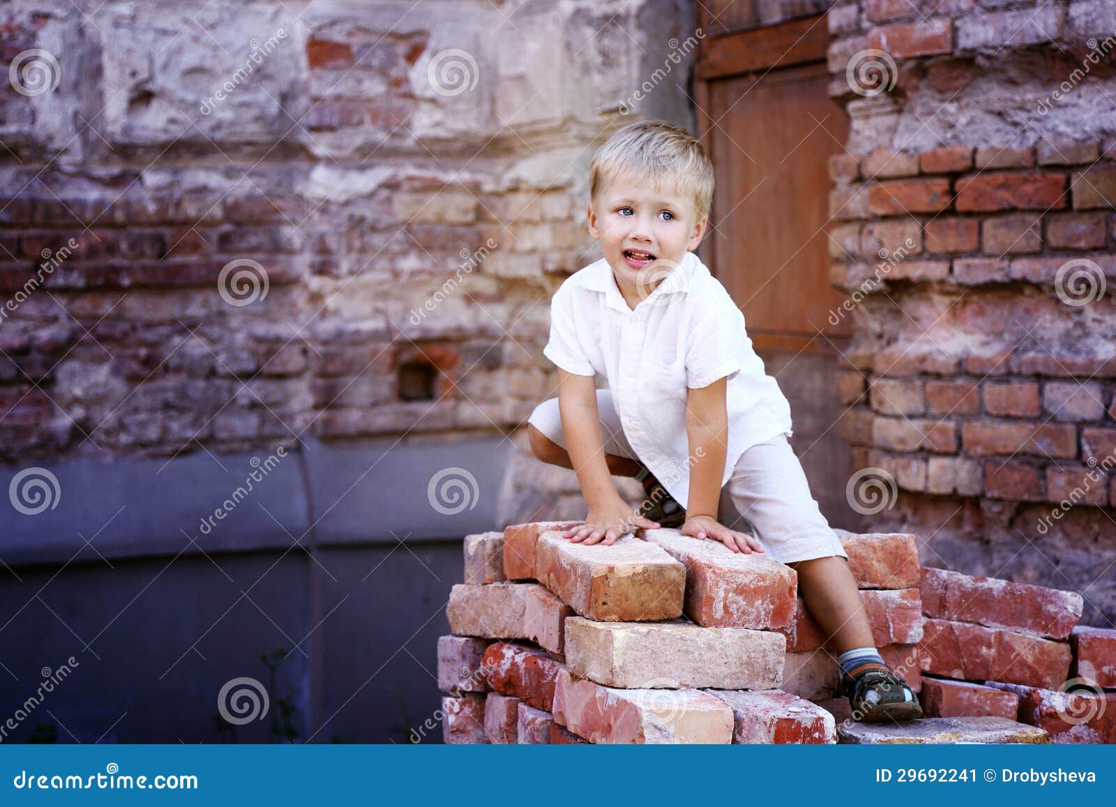 Cute Little Boy Sitting on Bricks Stock Image - Image of child ...