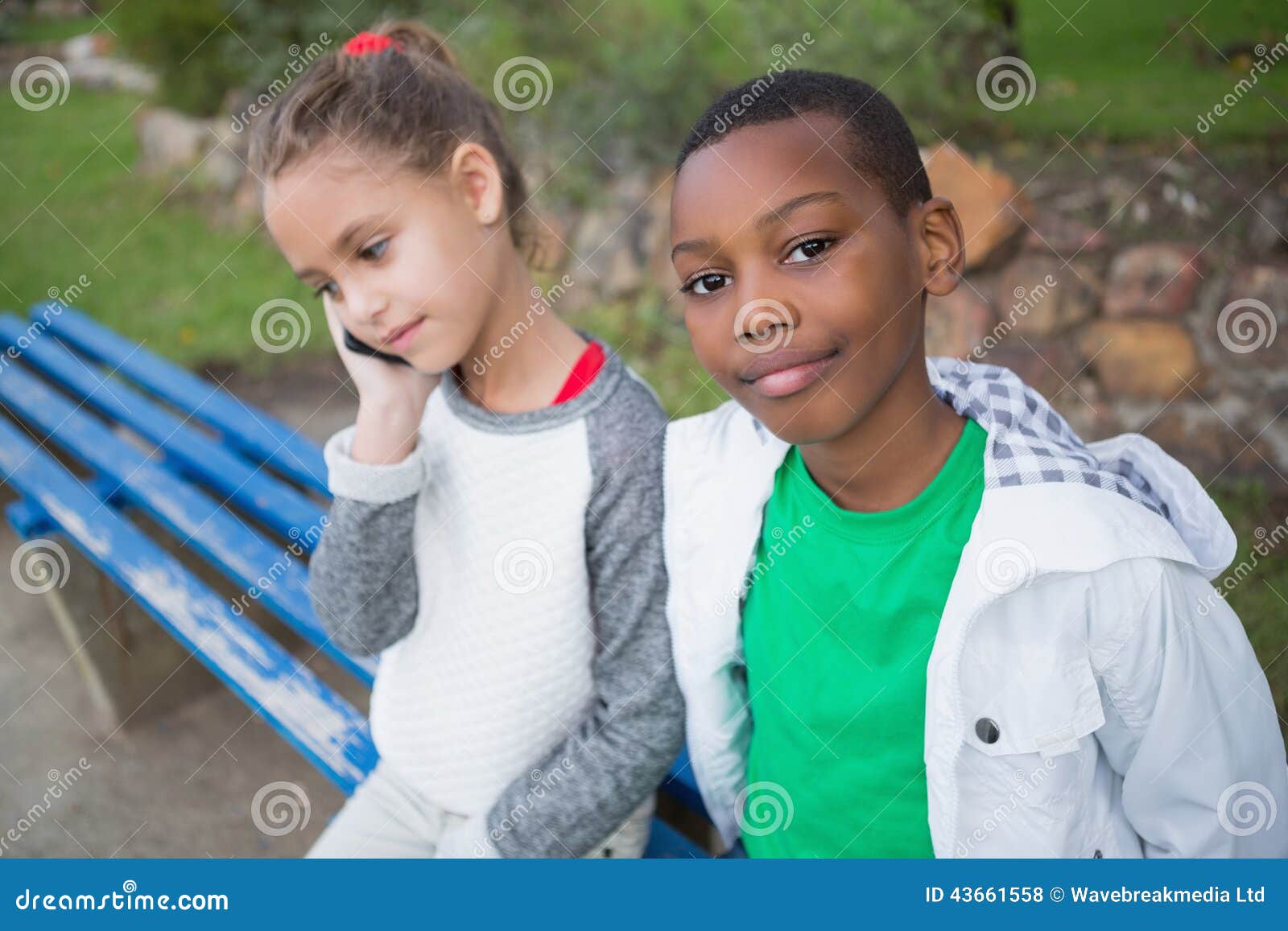 Cute Little Boy Smiling at Camera while Friend Talks on Phone Stock ...