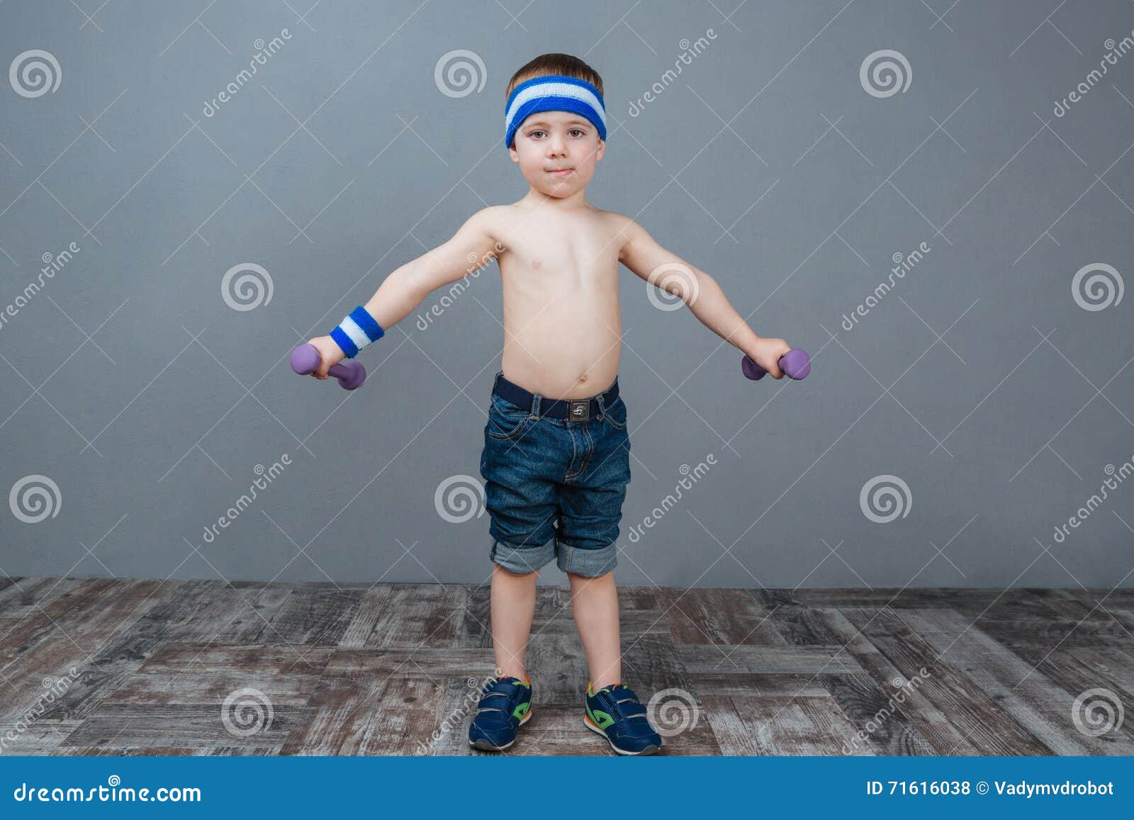 Cute Little Boy Standing Working Out Using Dumbbells Stock Photos ...