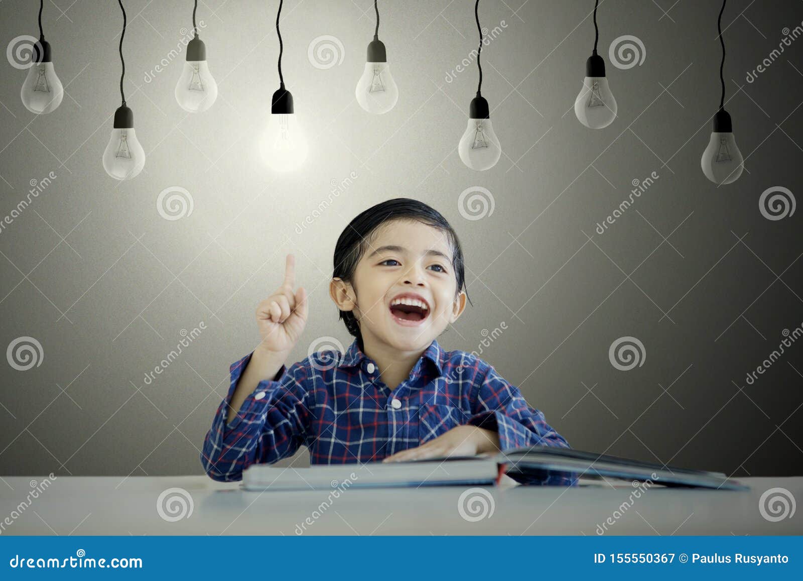 Cute Little Boy Studying Under a Bright Bulb Stock Image - Image of ...