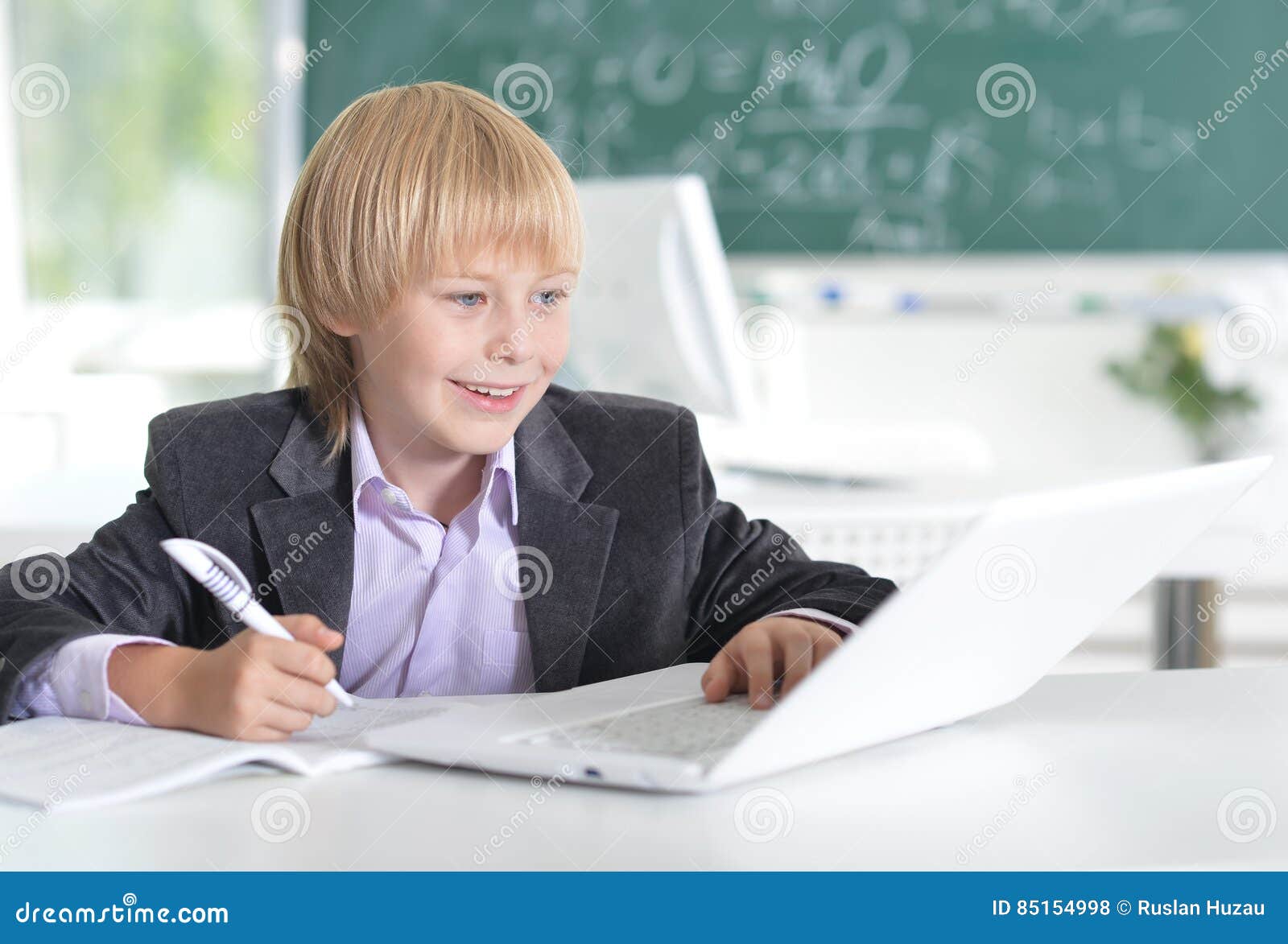Cute Little Boy Using Laptop Stock Photo - Image of device, elementary ...