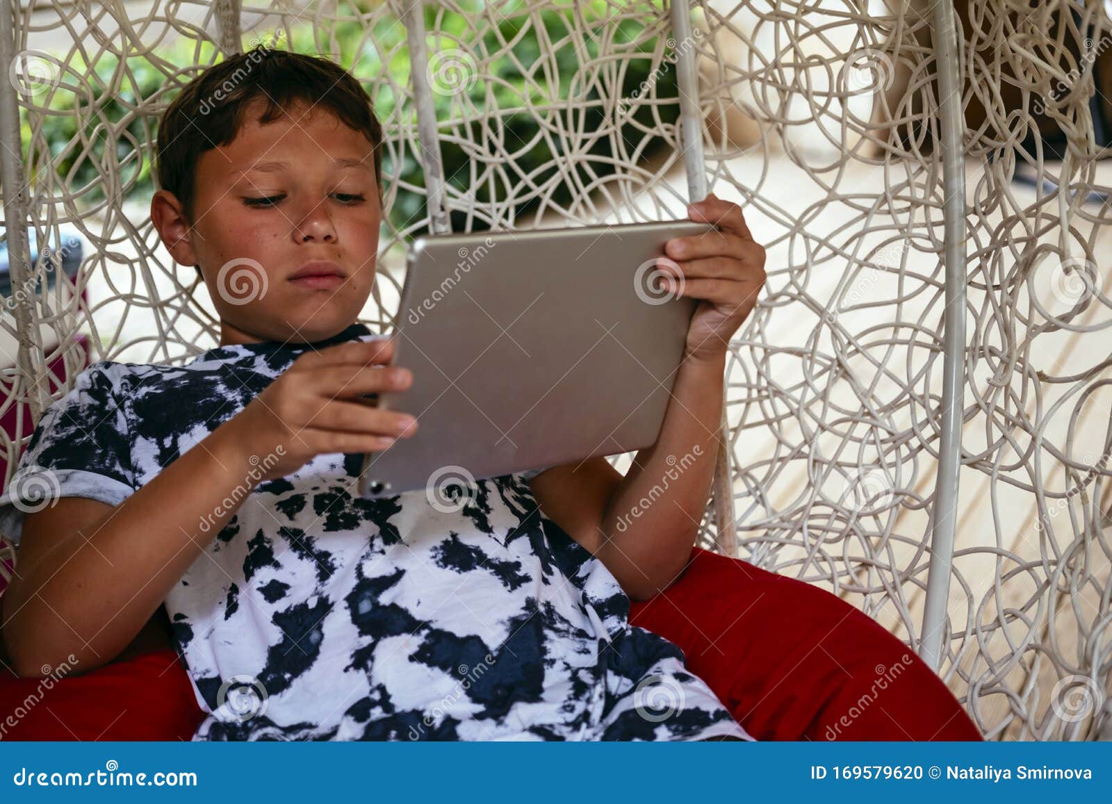 Cute Little Boy Using Tablet in Sunlit Park Stock Photo - Image of ...