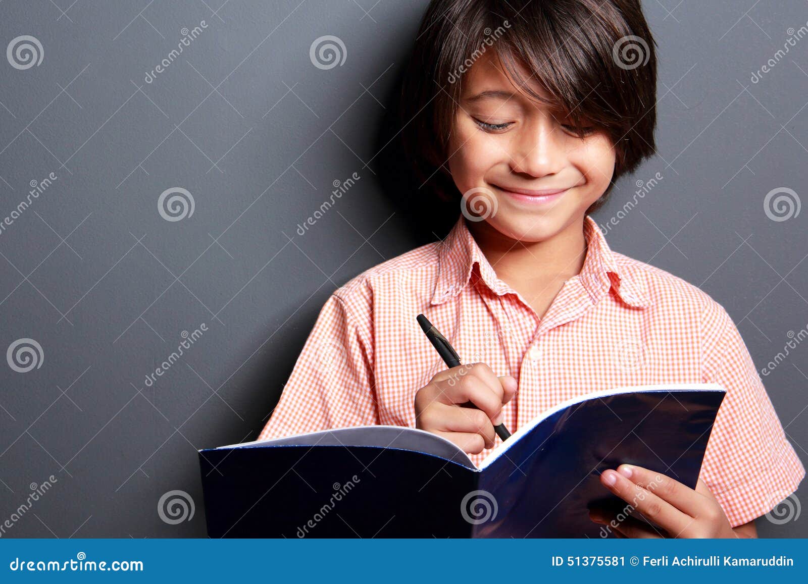 Cute Little Boy Writing on a Book Stock Image - Image of dark, concepts ...