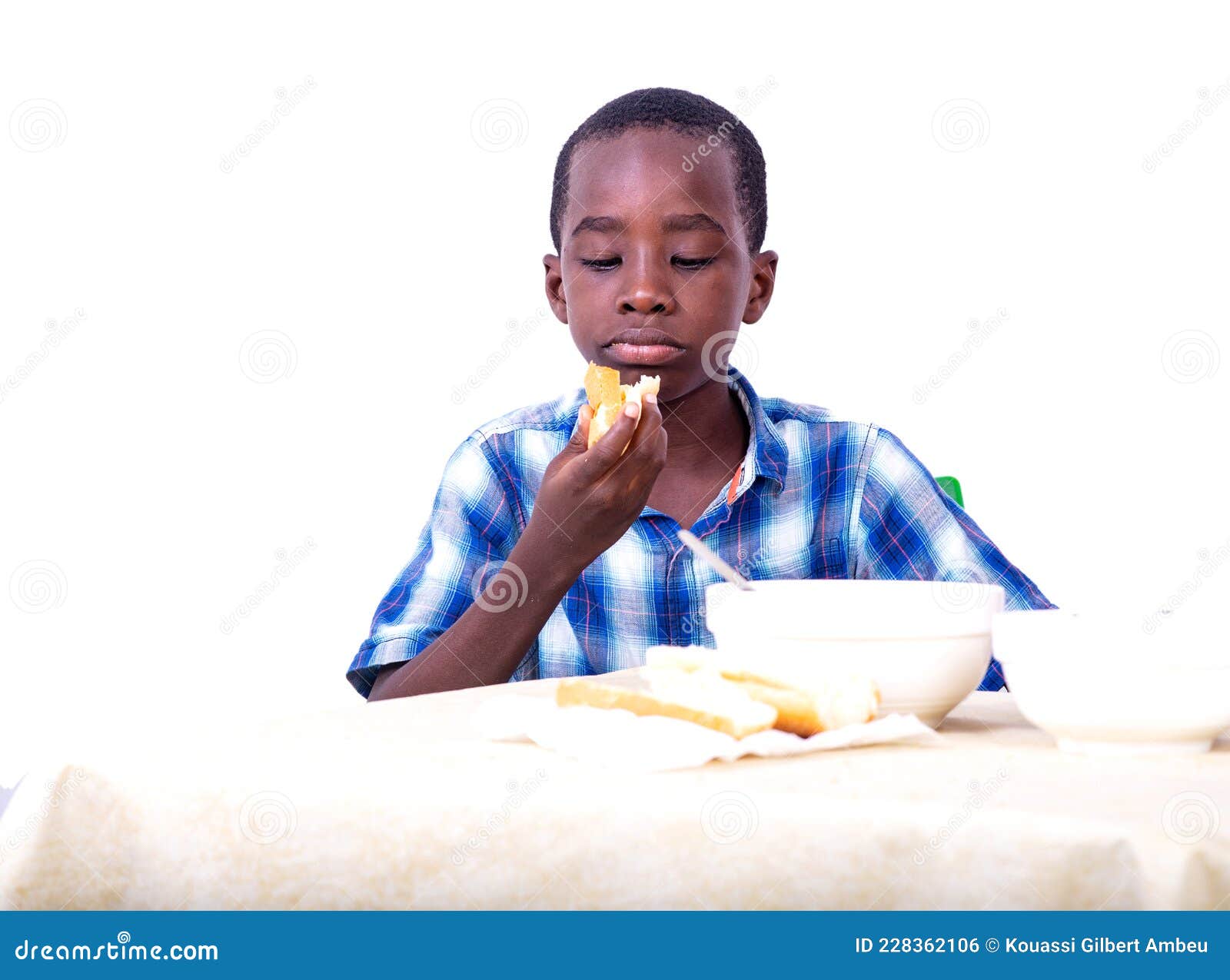 Cute Little Boys Eating a Piece of Bread at the Table Stock Photo ...