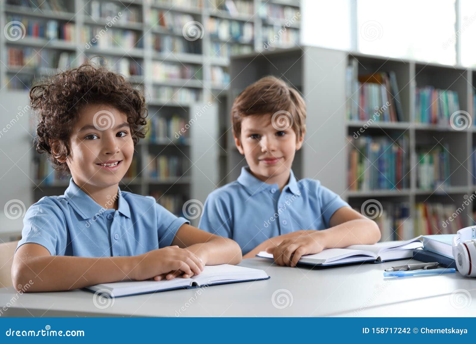 Cute Little Boys Reading Books at Table Stock Photo - Image of happy ...