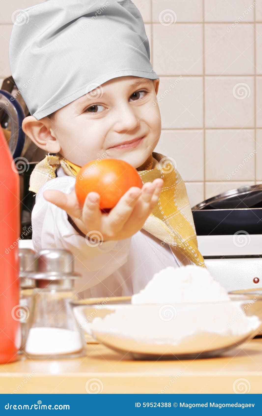 Cute Little Cook Giving Tomato Stock Photo - Image of child ...