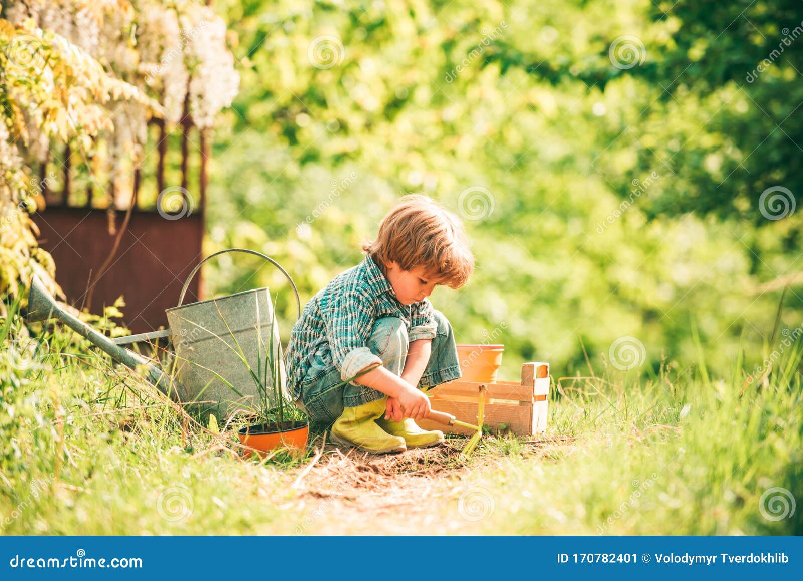 Cute Little Farmer Working with Spud on Spring Field. Gardening ...