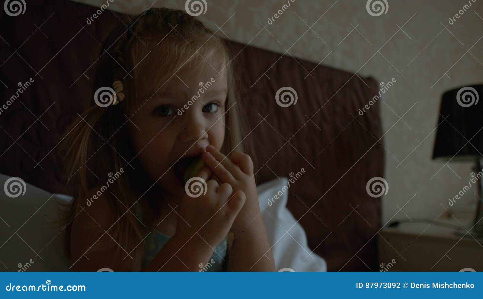 Cute Little Girl Chewing the Apple Stock Photo - Image of indoors ...