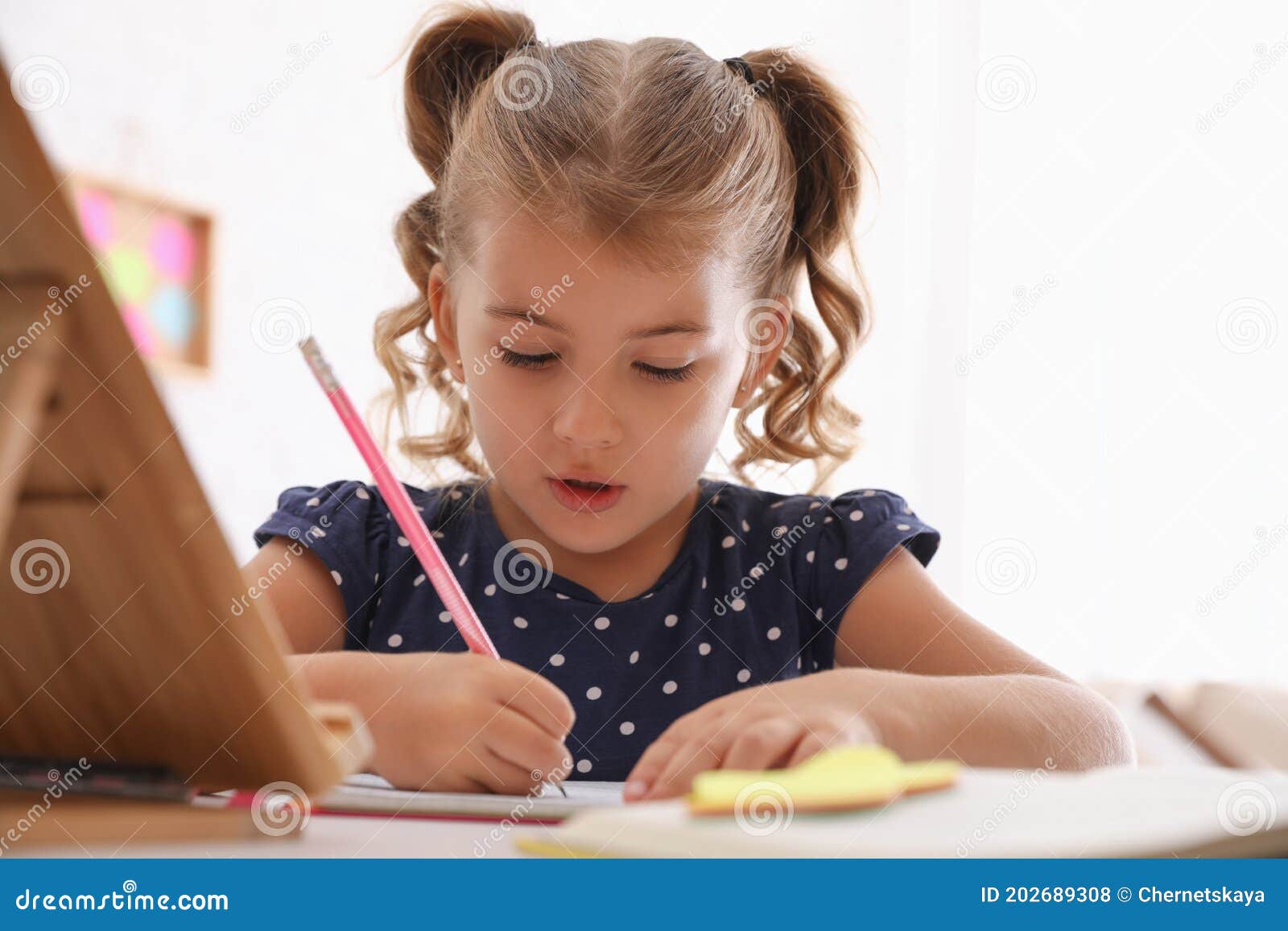 Cute Little Girl Doing Homework at Table Stock Photo - Image of ...