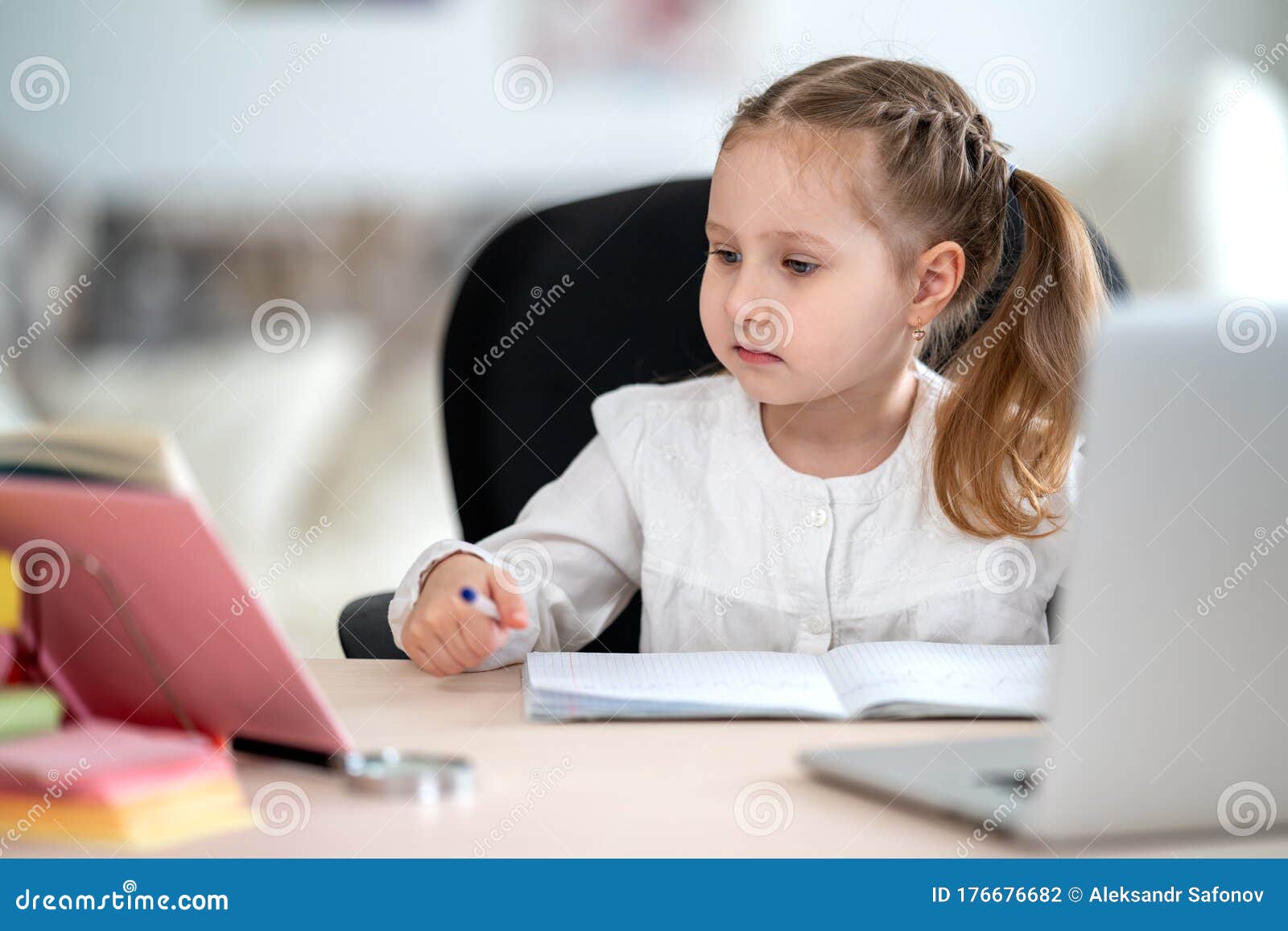 Cute Little Girl, Doing Homework, Writing in Notebook, Using Laptop, E ...