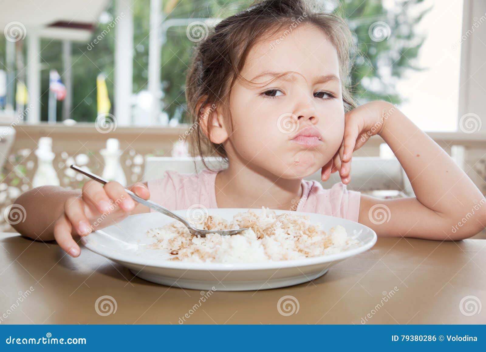 Cute Little Girl Eats Rice in a Summer Cafe Stock Photo - Image of ...