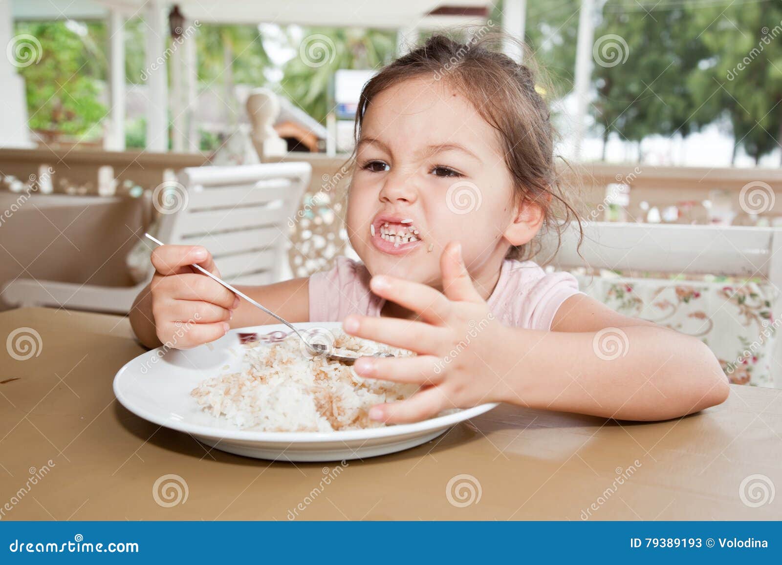 Cute Little Girl Eats Rice in a Summer Cafe Stock Image - Image of ...