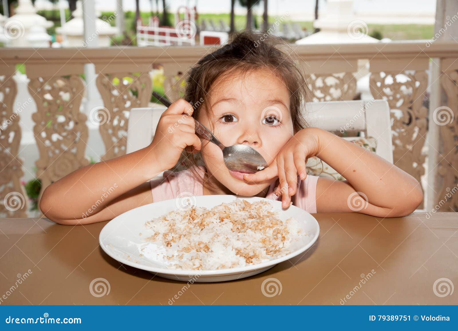 Cute Little Girl Eats Rice in a Summer Cafe Stock Image - Image of ...