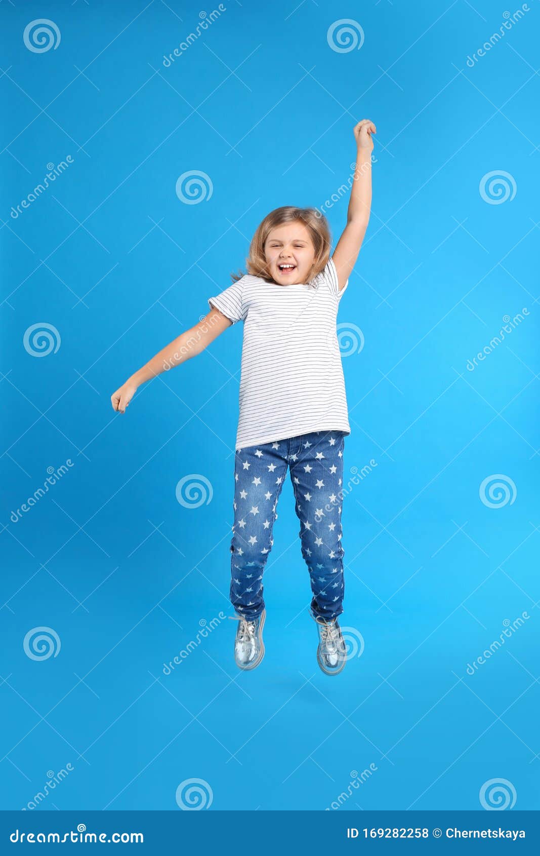 Cute Little Girl Jumping on Blue Background Stock Photo - Image of cute ...